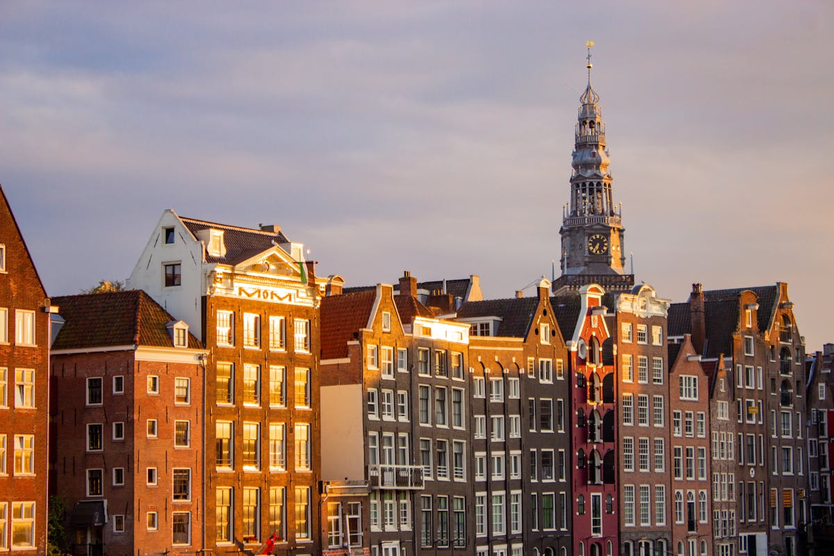 Traditional canal houses along an Amsterdam canal at sunset