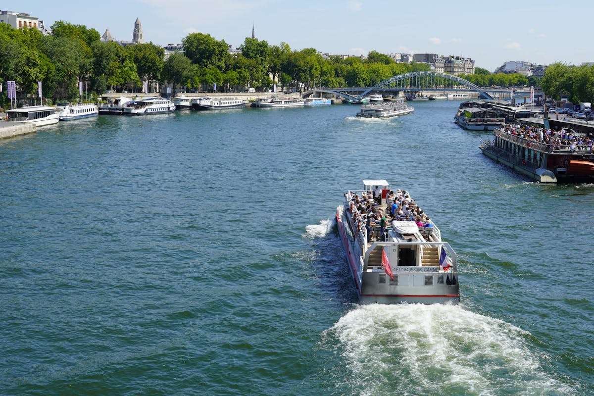 Tourist boat on the Seine River in Paris during a bright sunny day