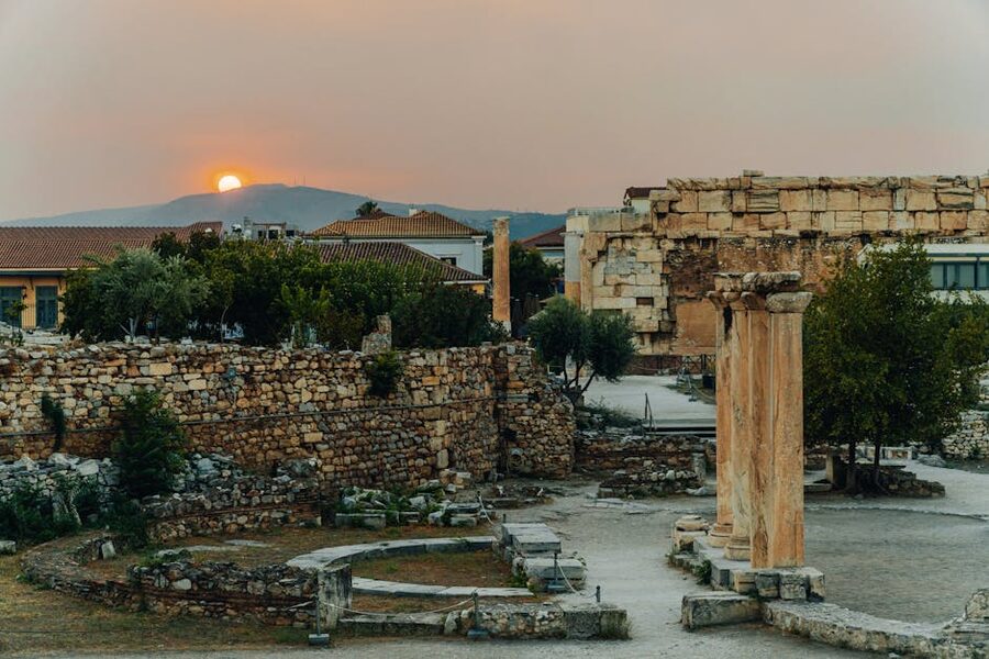 Sunset view of ancient ruins in Athens with historical architecture