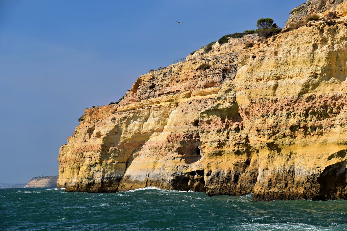 Breathtaking view of rugged cliffs along the Algarve coast in Faro District Portugal