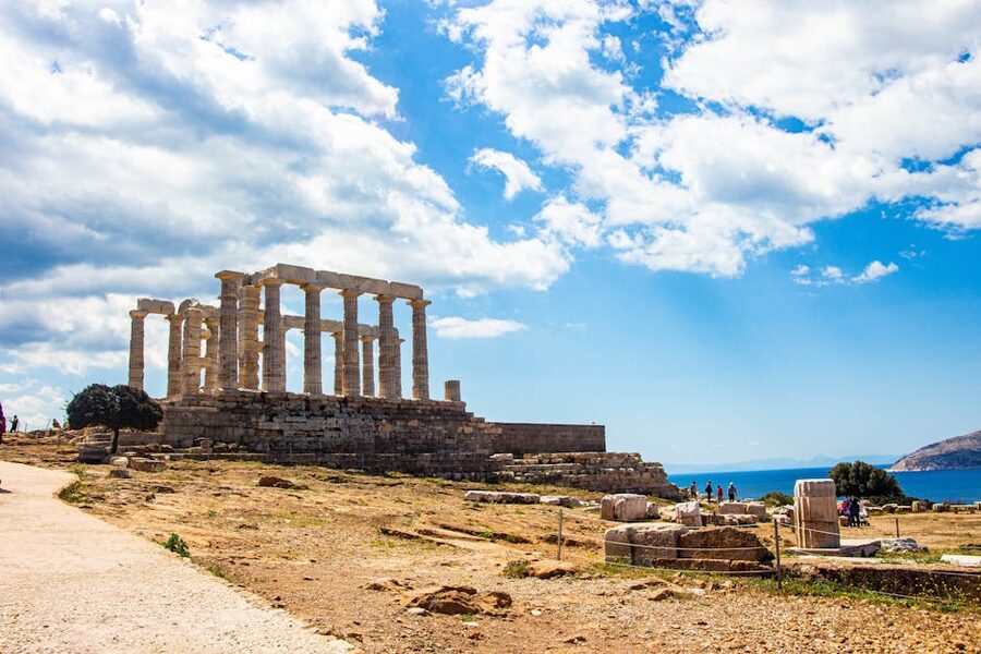 Iconic Temple of Poseidon at Cape Sounion, Greece, under a vibrant blue sky