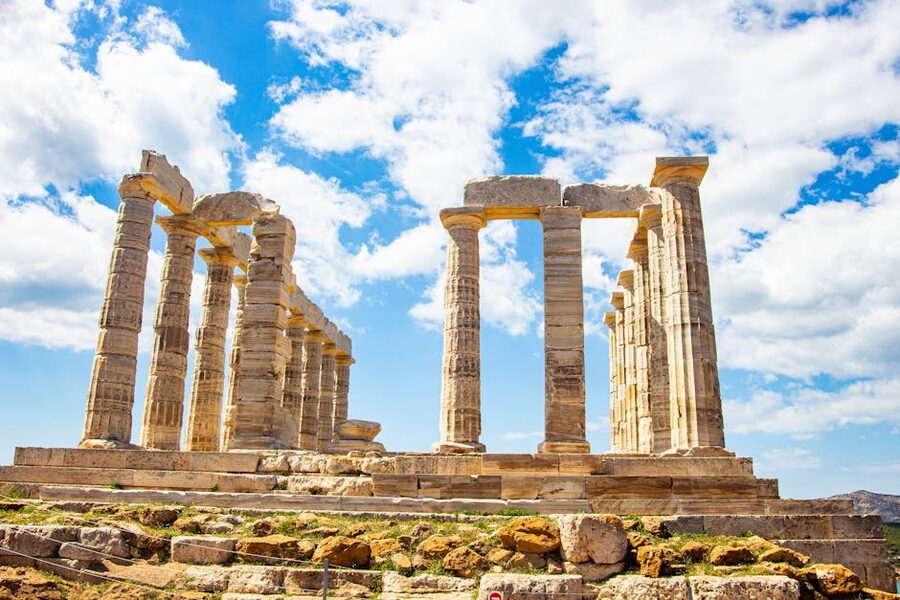 Ruins of an ancient Greek temple beneath a vibrant blue sky