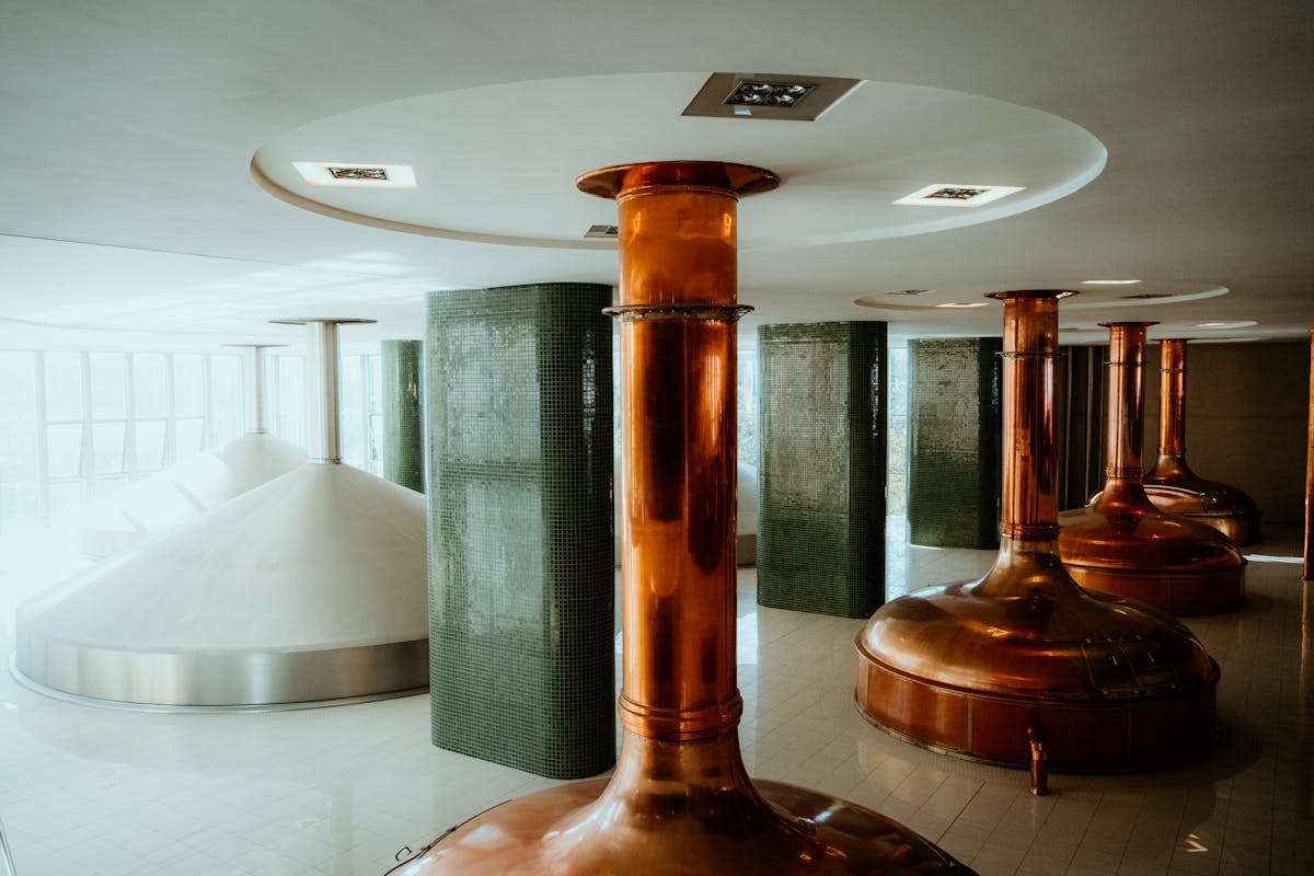 Interior view of a brewery with copper tanks and modern design elements