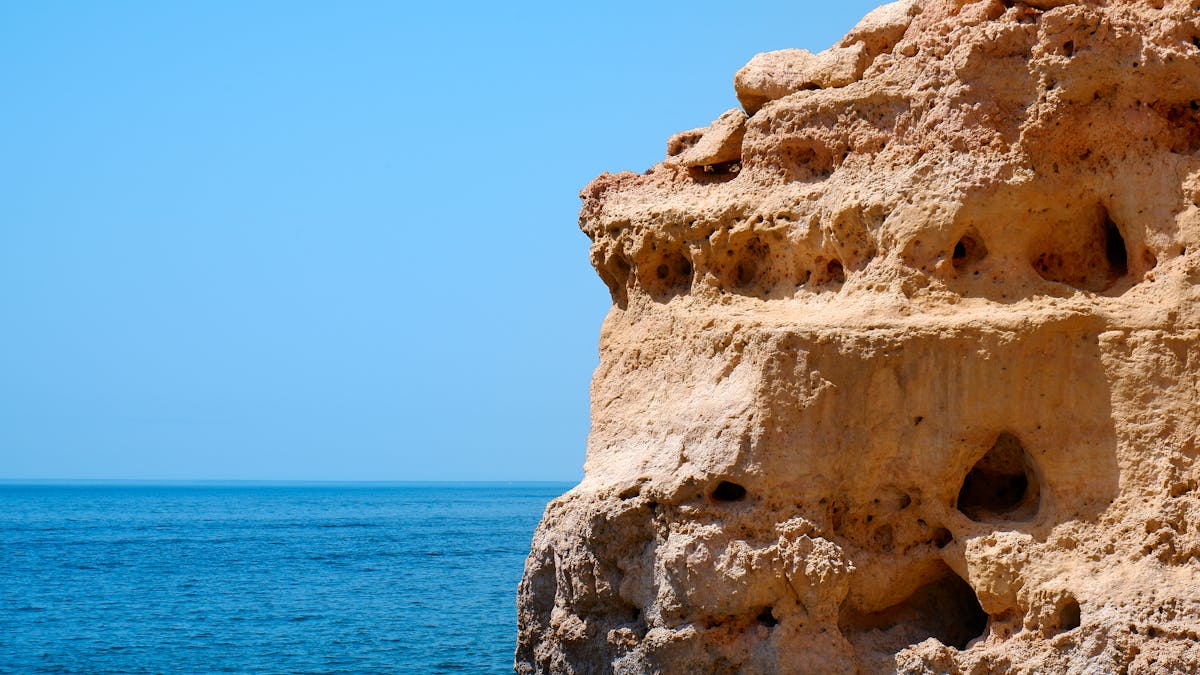 Limestone cliffs against the azure Atlantic Ocean in Algarve Portugal