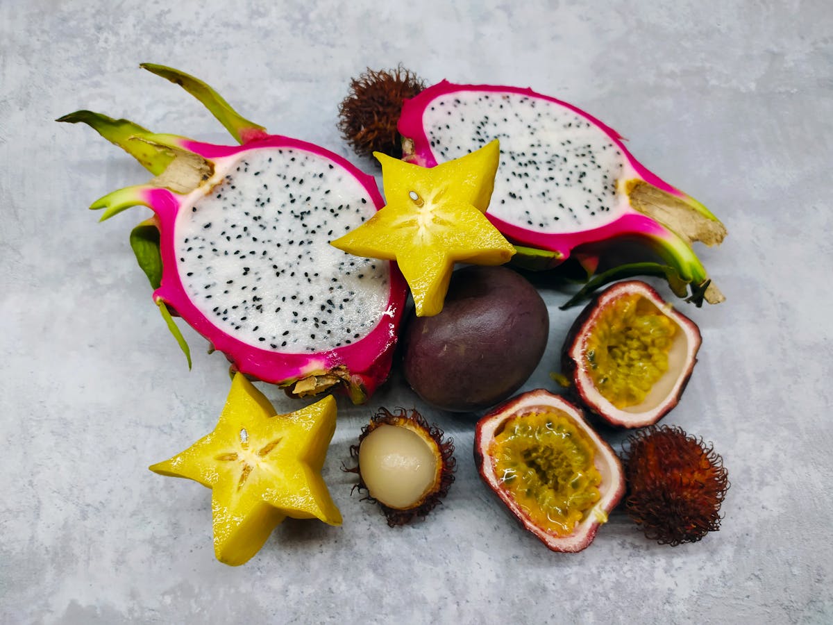 A colorful assortment of tropical fruits including dragon fruit starfruit and passion fruit