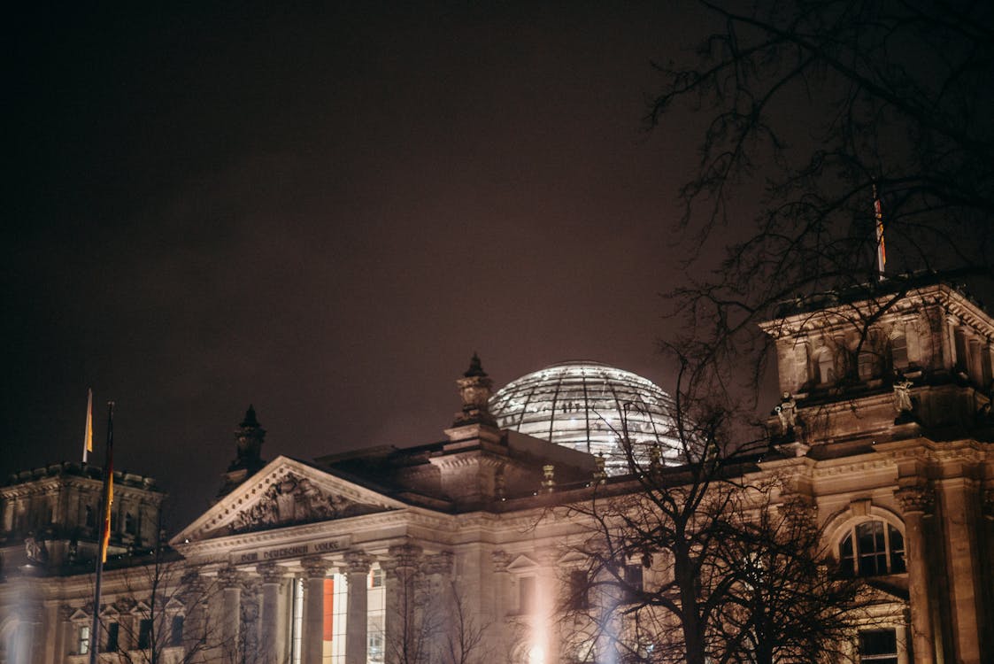 Illuminated Reichstag Building at night with glowing glass dome Berlin