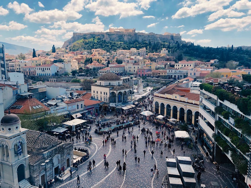 Aerial shot of Monastiraki Square bustling with people, framed by the Acropolis