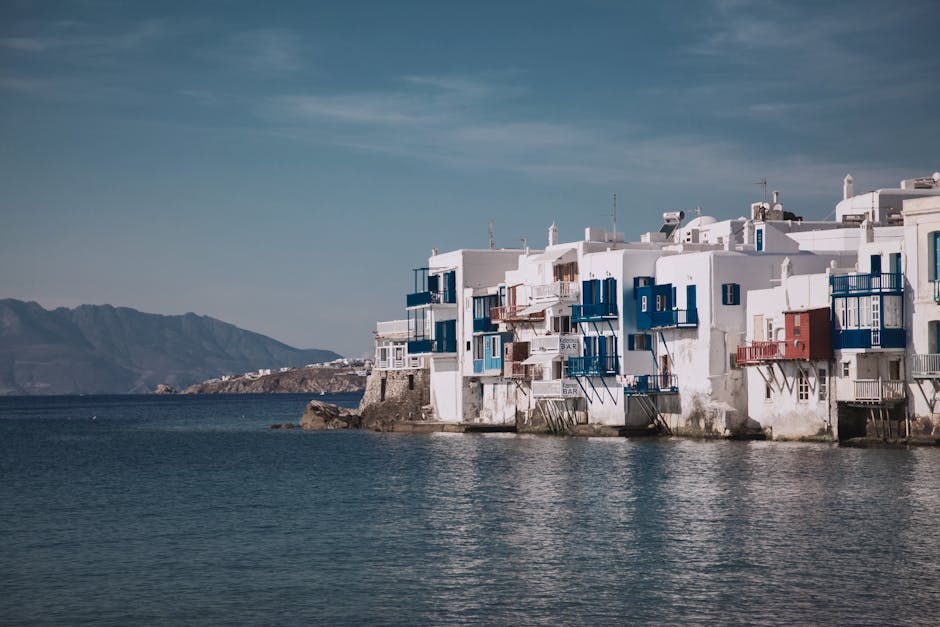 Iconic blue and white houses of Mykonos perched by the Aegean Sea
