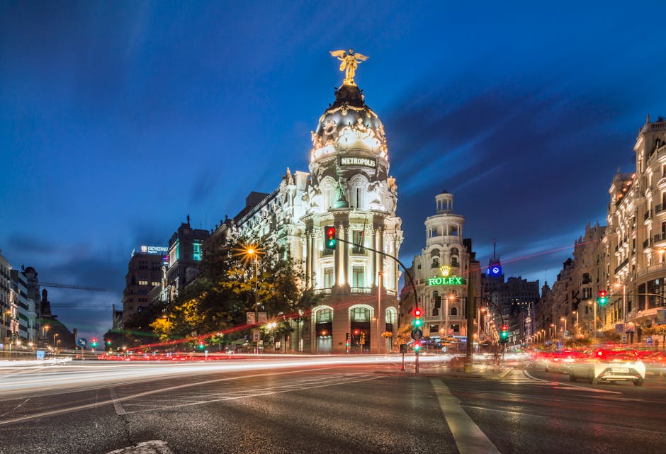 Stunning night view of the Metropolis Building in Madrid with light trails from traffic