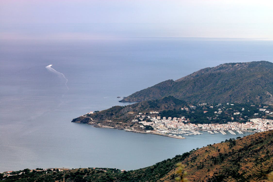 A stunning aerial view of a coastal town in Spain showcasing its harbor