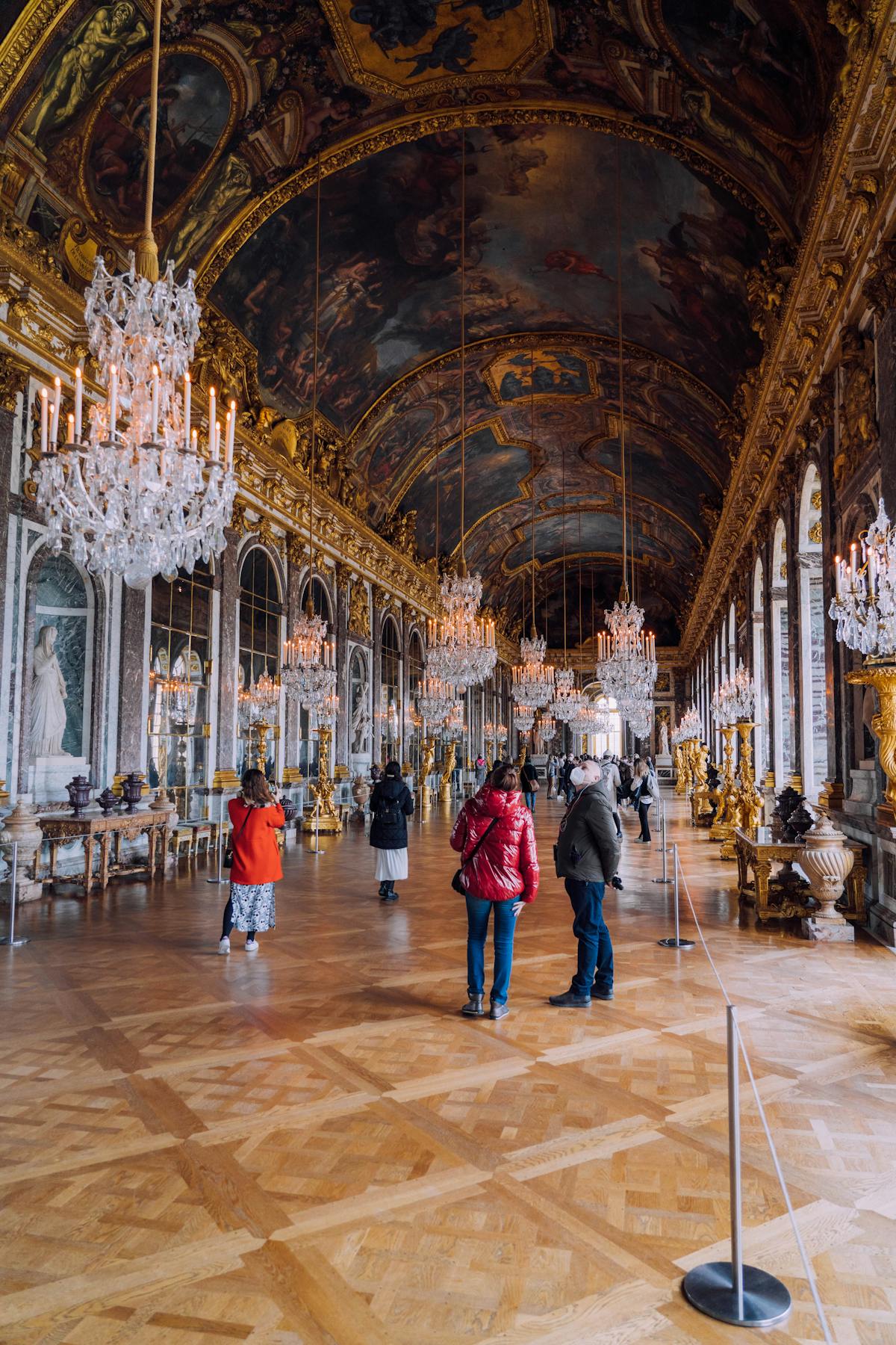 Opulent Hall of Mirrors at Versailles with crystal chandeliers and gilded arches