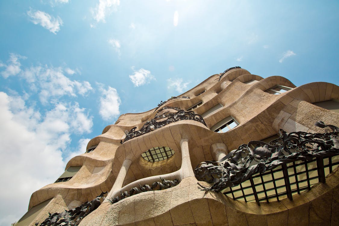 Low angle view of Casa Mila unique architectural facade against a sky