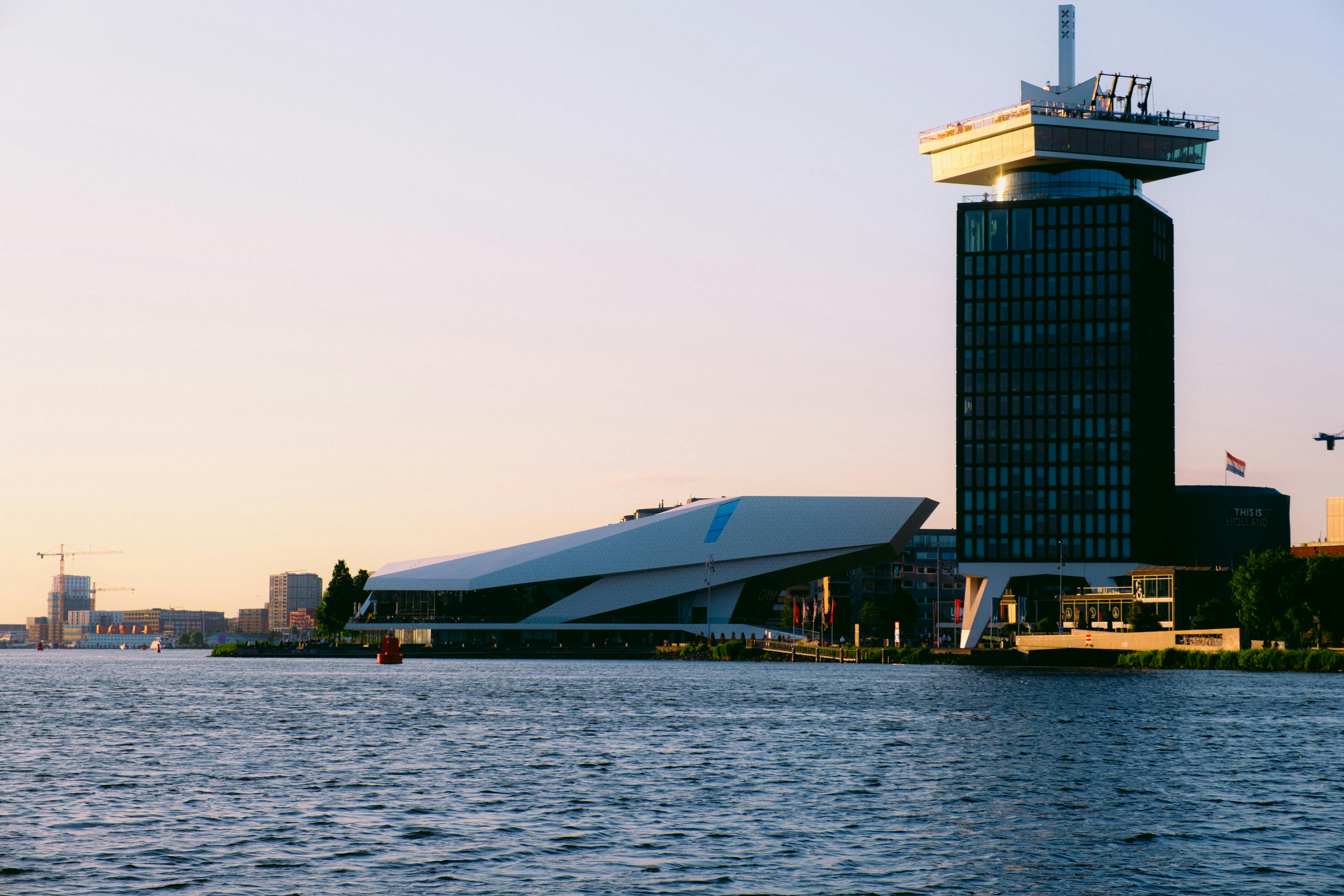 Modern architecture along Amsterdam waterfront at golden hour sunset