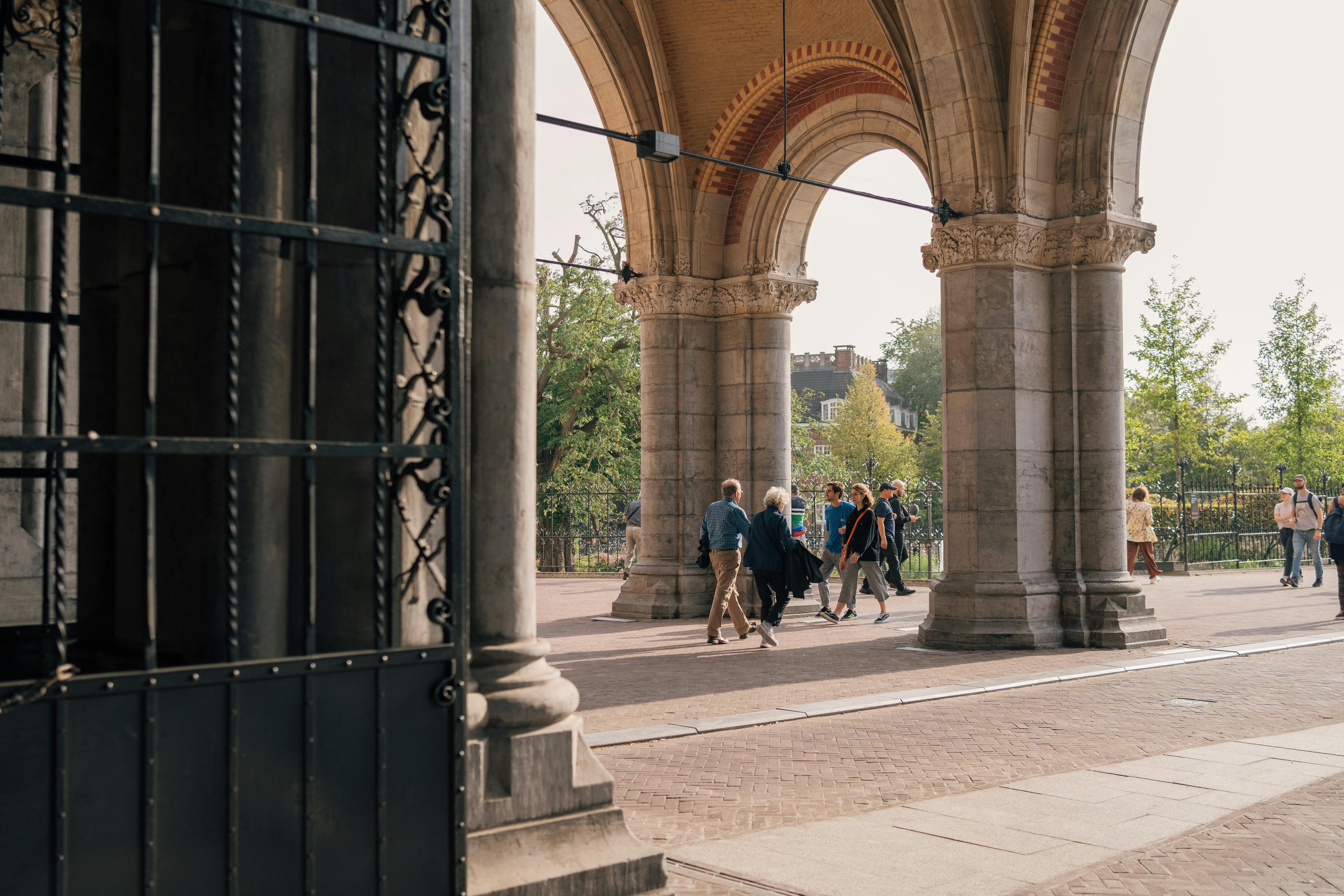 People walking through the arches of the Rijksmuseum in Amsterdam