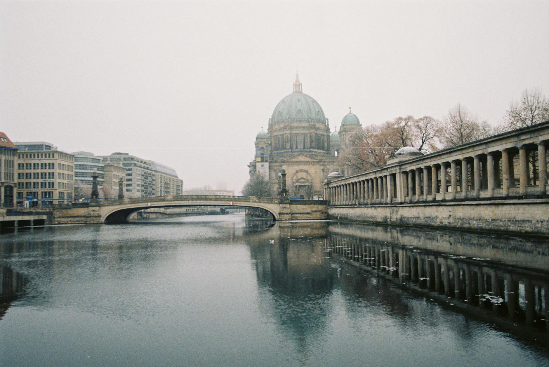 Berlin Cathedral and a historic bridge enveloped in fog