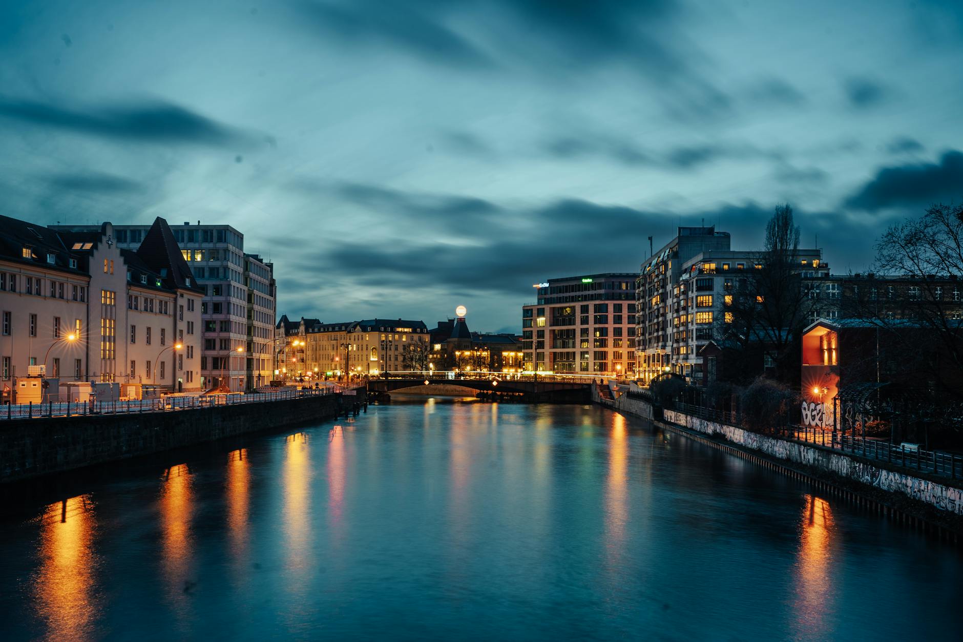 Twilight view of Berlin cityscape with reflections on Spree River showing modern architecture