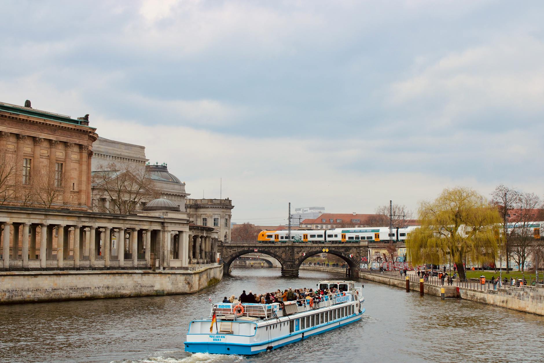 Tourists enjoying a scenic boat ride along the Spree River in central Berlin during spring