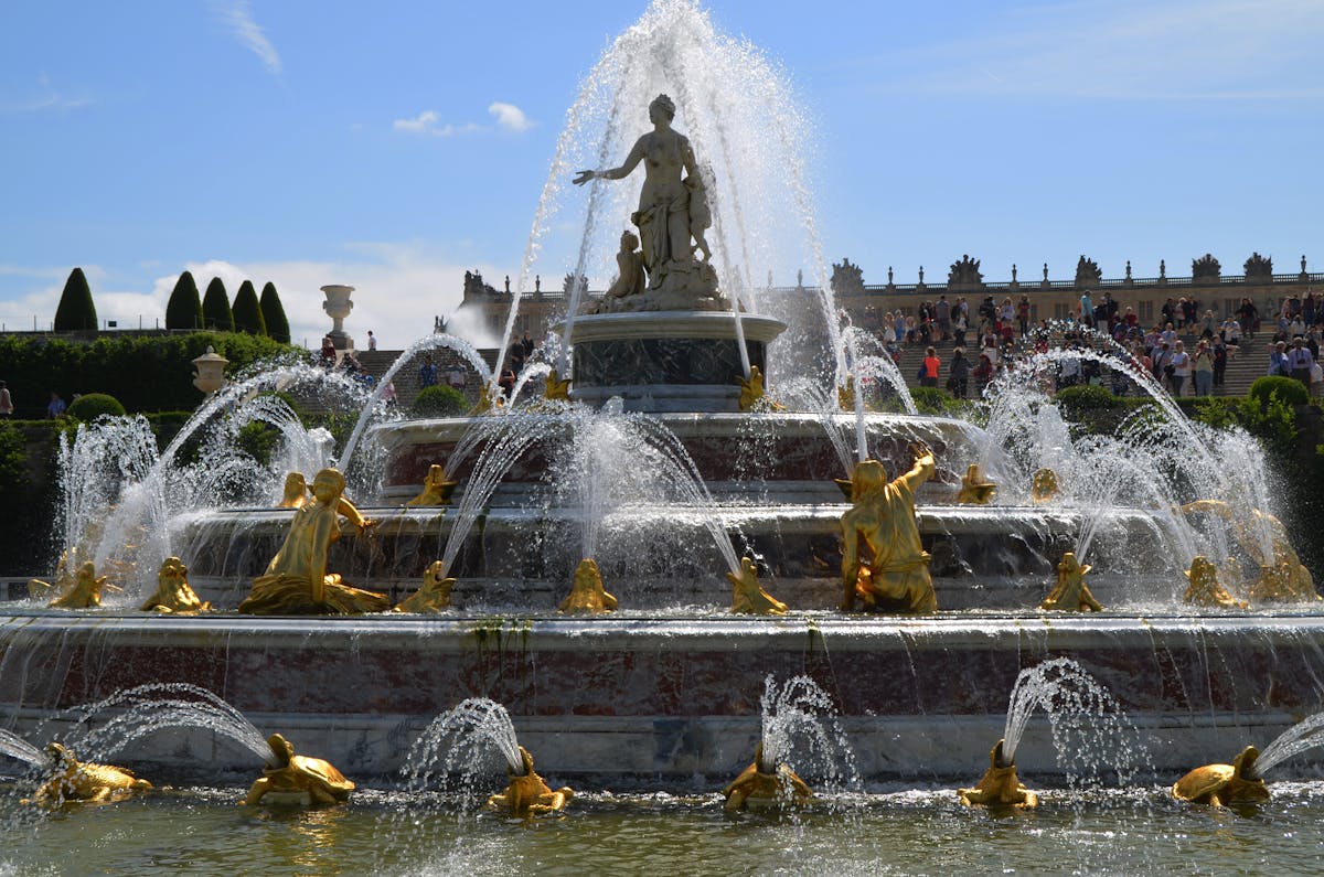 Golden Fountain of Apollo statues in the gardens of Versailles