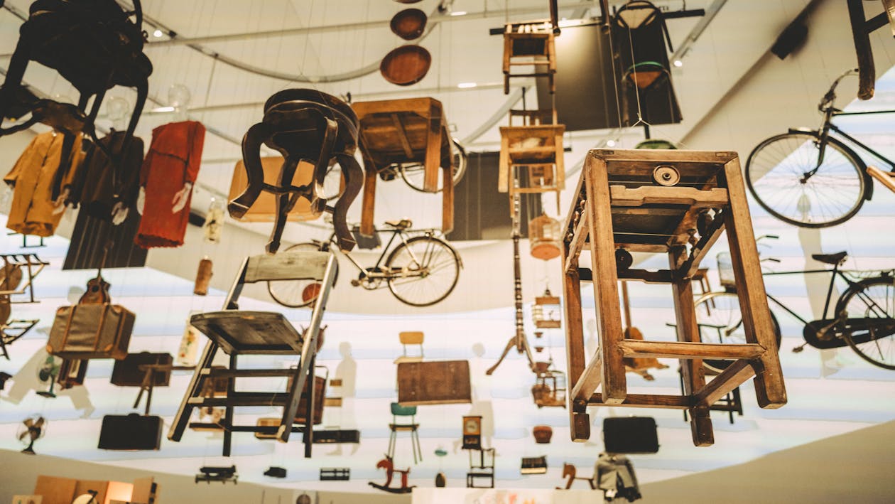 Unique art installation of vintage furniture and bicycles suspended in mid-air