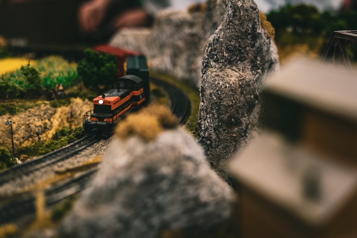 A miniature train navigating through a detailed model landscape