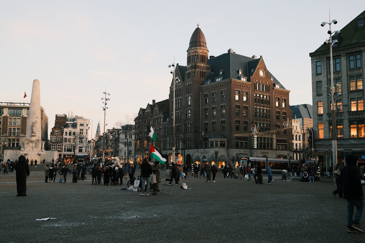 Evening view of Dam Square Amsterdam featuring the National Monument and surrounding architecture