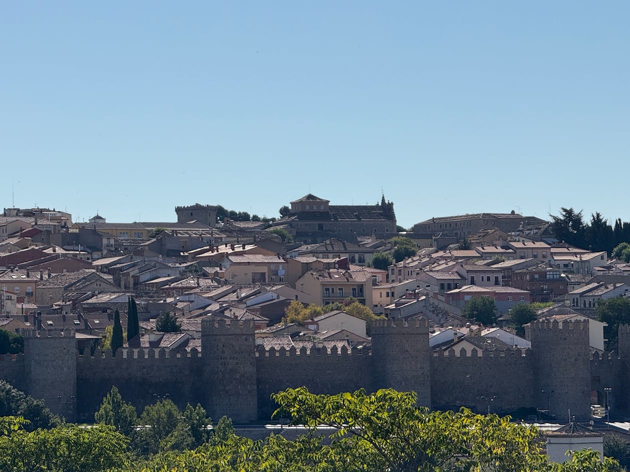 Panoramic view of Avila medieval walls under a clear blue sky in Spain