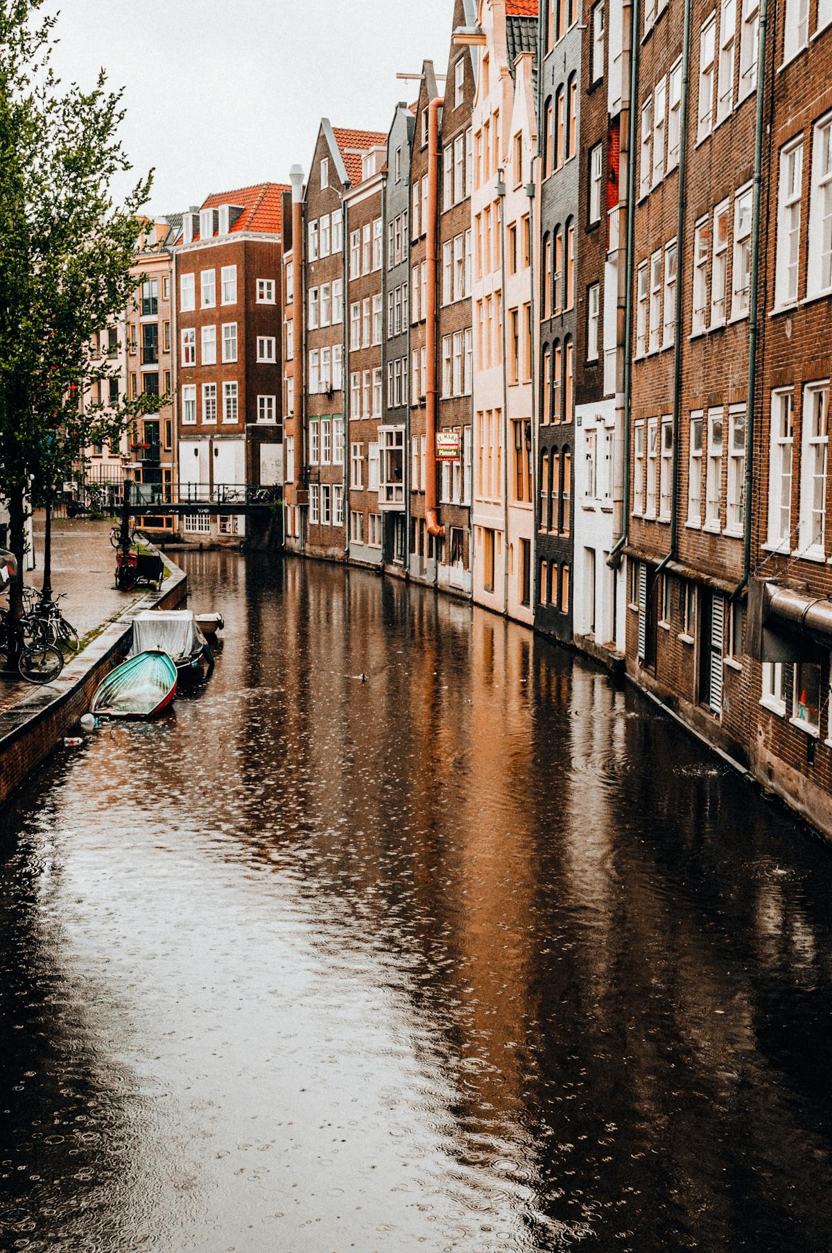 Picturesque Amsterdam canal lined with historic brick buildings reflecting in the water