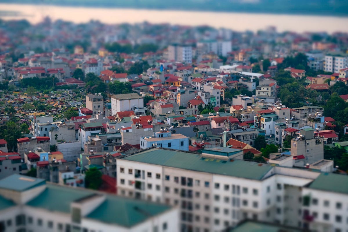 Aerial cityscape with vibrant rooftops captured in tilt shift style