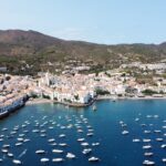 Stunning aerial view of the charming coastal town Cadaques with sailboats and azure water