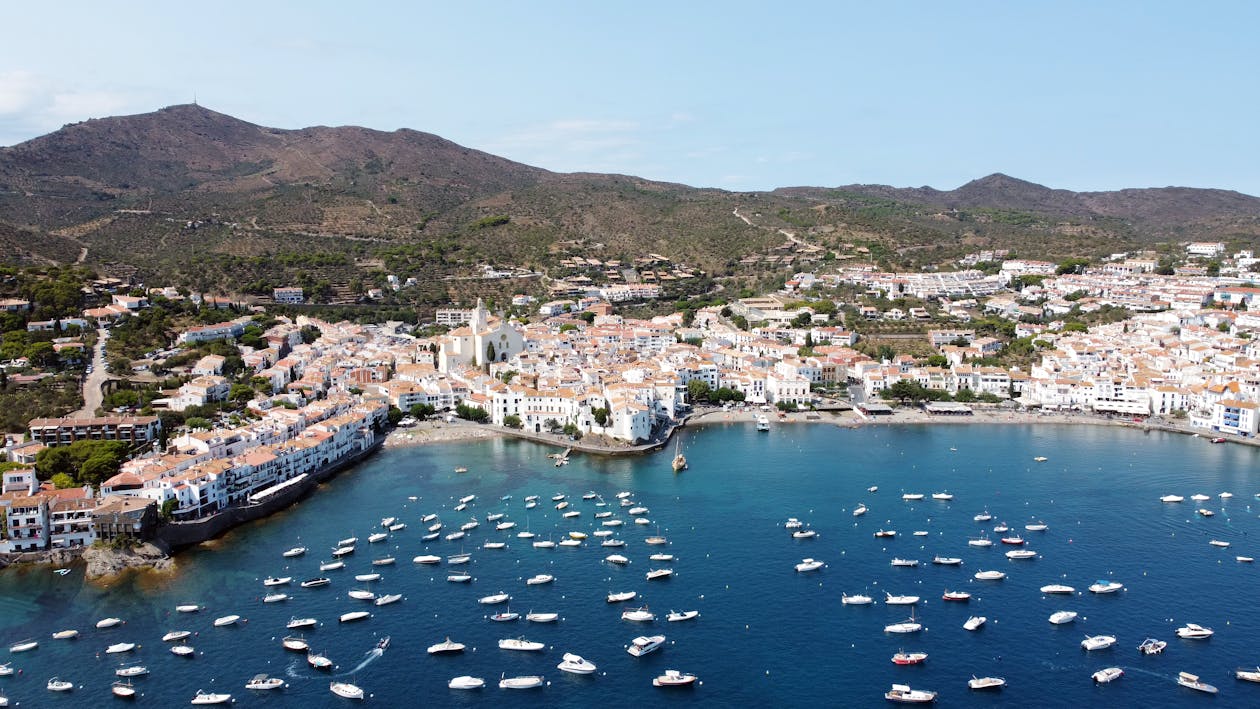 Stunning aerial view of the charming coastal town Cadaques with sailboats and azure water