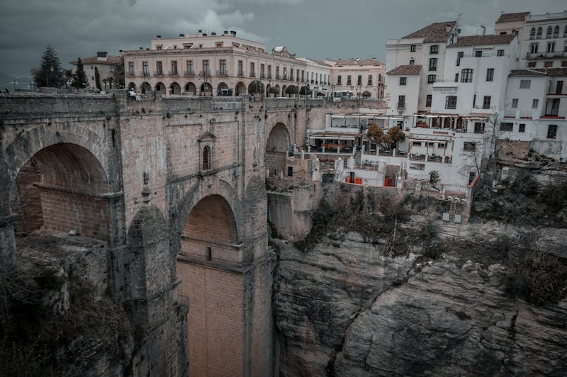 Dramatic perspective of the Puente Nuevo bridge arching over the deep gorge in Ronda Spain