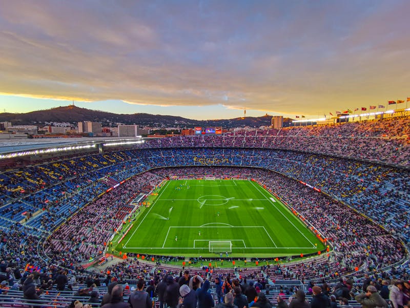 Aerial view of Camp Nou stadium filled with spectators during a football match at night