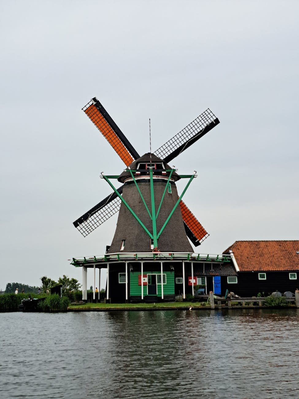 Classic windmill reflected in calm water at Zaanse Schans, Zaandam