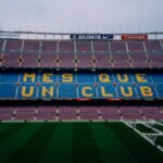 Camp Nou stadium interior showing colorful seats spelling out Mes Que Un Club in Barcelona