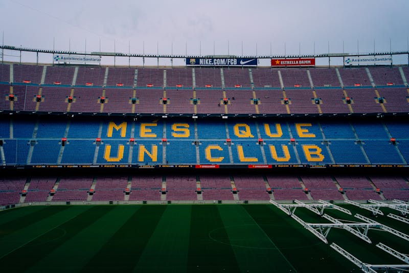 Camp Nou stadium interior showing colorful seats spelling out Mes Que Un Club in Barcelona