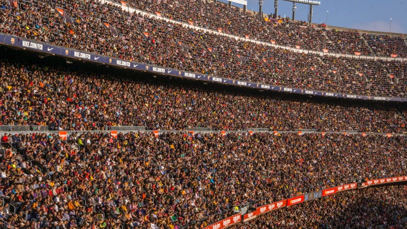 Crowd of supporters watching an FC Barcelona football match at Camp Nou stadium