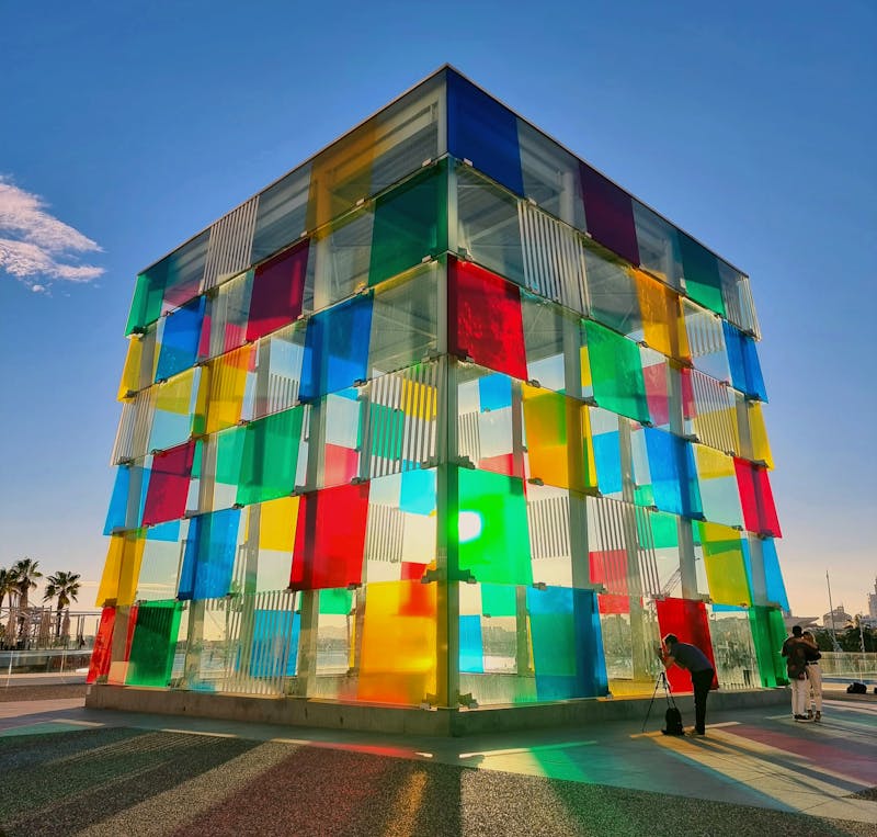 Colorful glass cube structure of Centre Pompidou Malaga reflecting sunlight at the port area