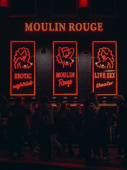 Crowd outside an iconic nightlife venue with bright neon sign