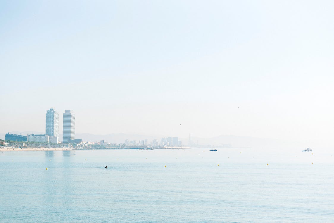 Barcelona skyline with skyscrapers viewed from the sea during sunrise