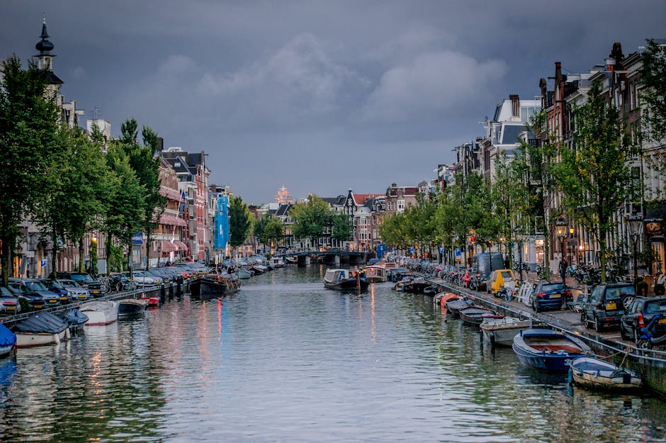 Picturesque view of an Amsterdam canal with boats and traditional architecture