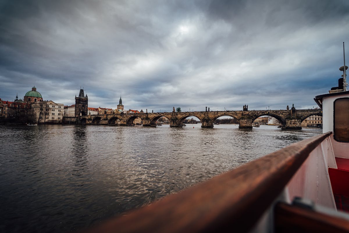 Charles Bridge spanning the Vltava River in Prague with historic architecture in the background