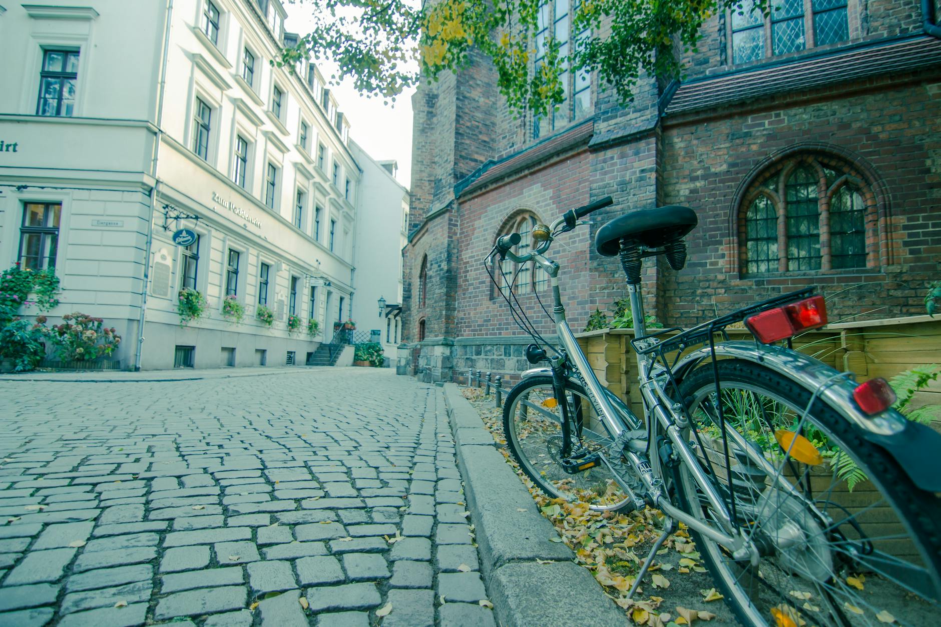 Bicycle against historic building on cobblestone Berlin street