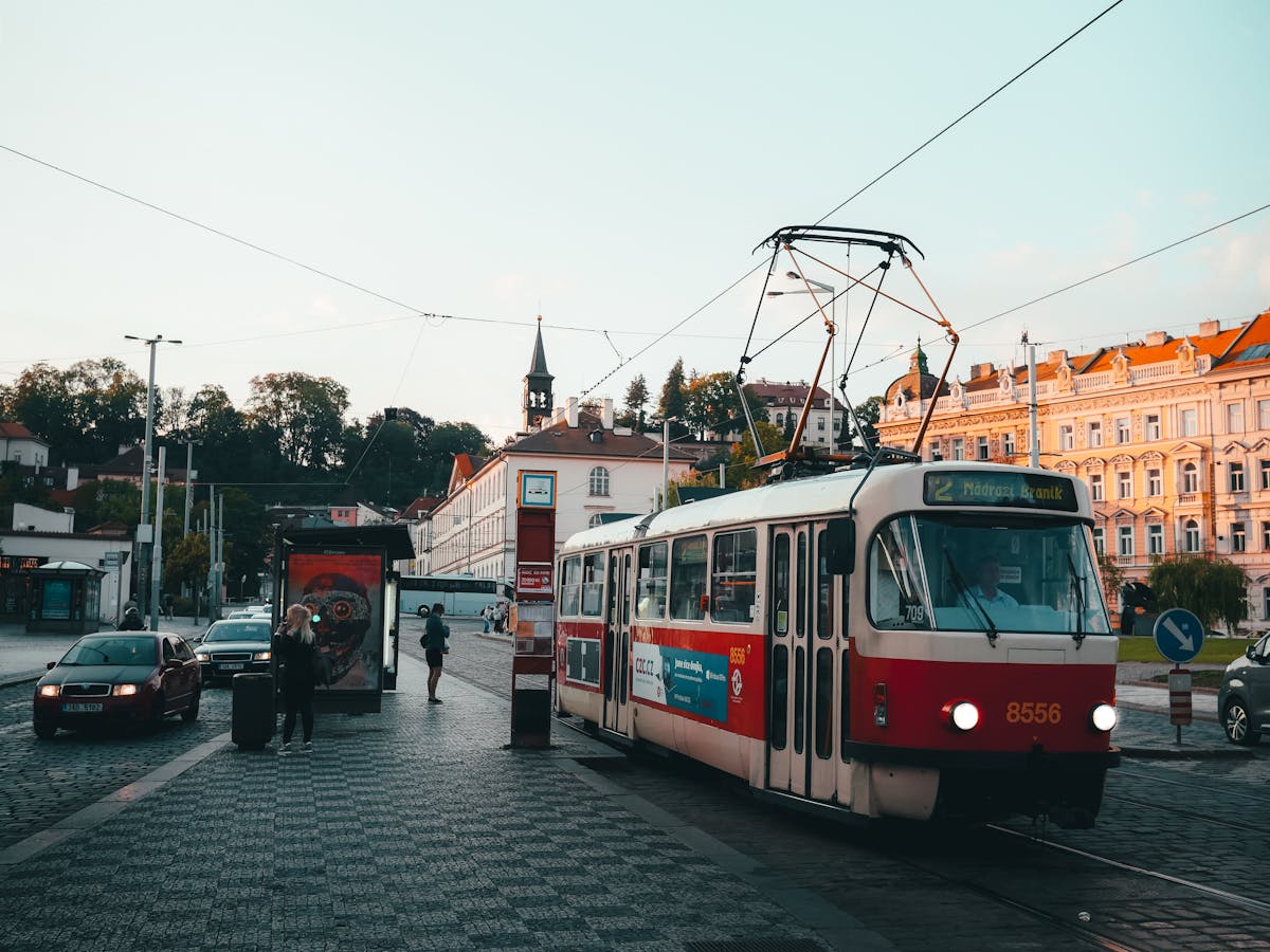 Vintage tram on cobblestone street in Prague at sunset