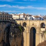 The Puente Nuevo bridge spanning the deep El Tajo gorge in Ronda, Spain, with white buildings perched on the cliff edge