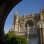 Ornate Gothic facade of Seville Cathedral showing detailed stone carvings and spires