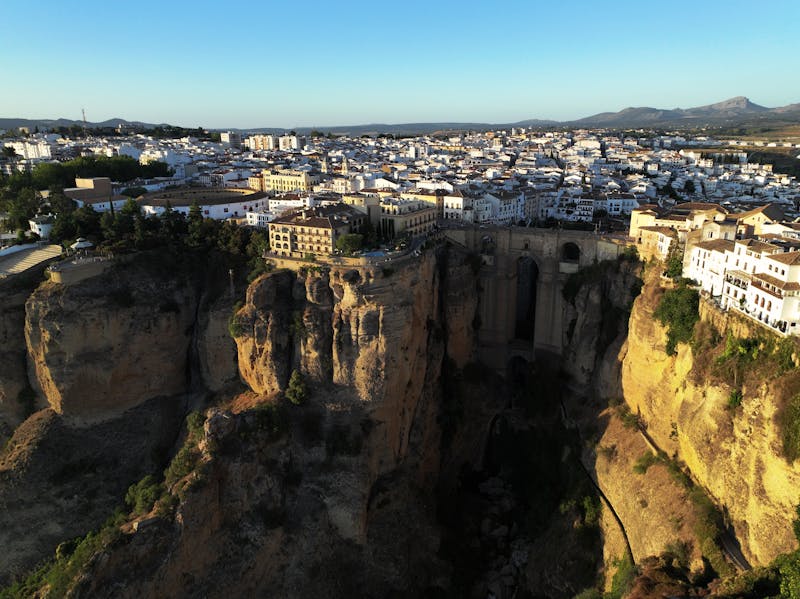 Aerial view looking down into El Tajo Gorge with buildings of Ronda on both sides