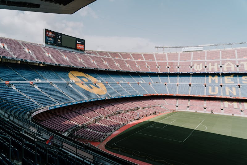 View of Camp Nou stadium from the upper stands showing the pitch and surrounding Barcelona cityscape