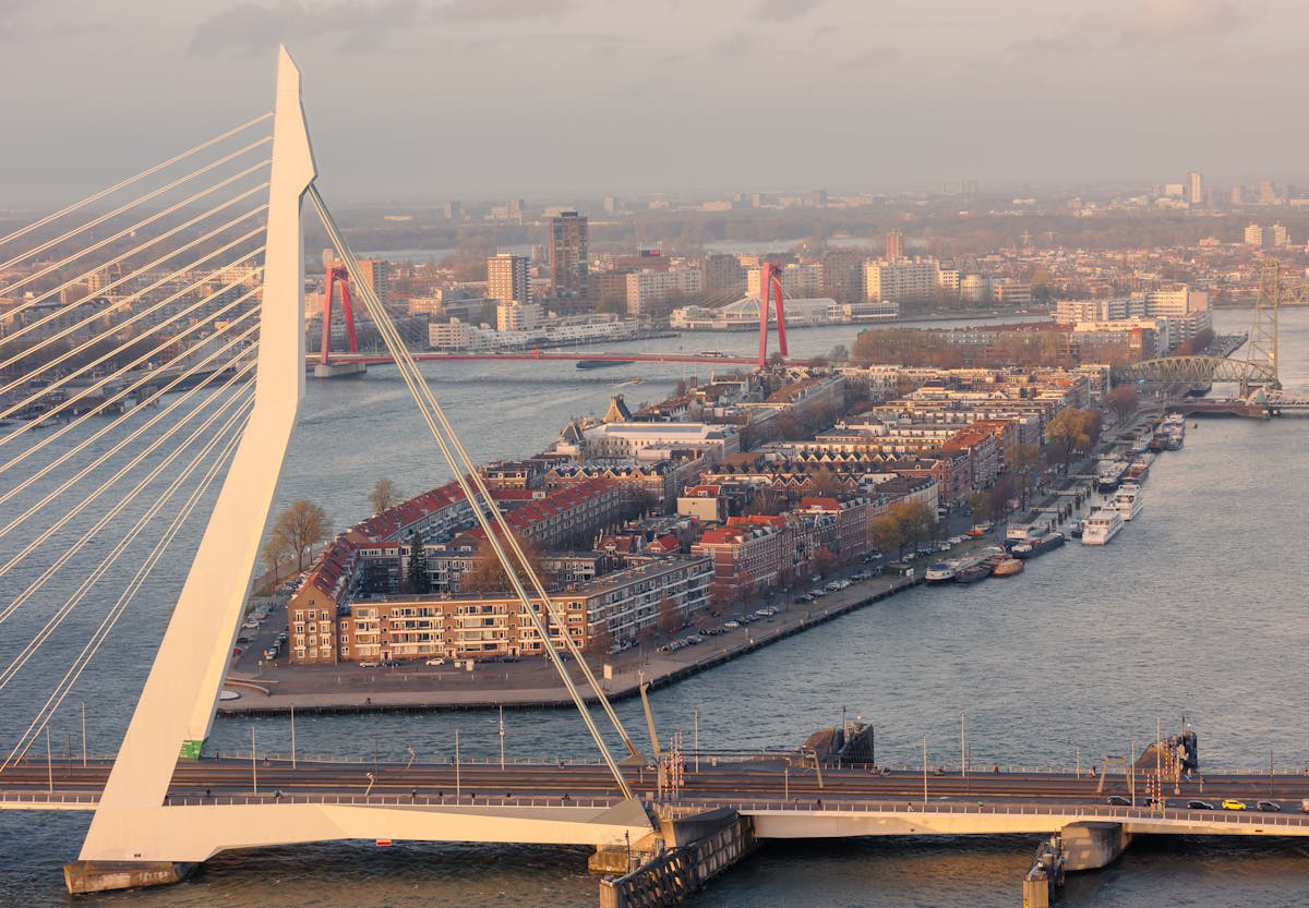 The Erasmus Bridge connects north and south Rotterdam across the Maas River with city skyline in background