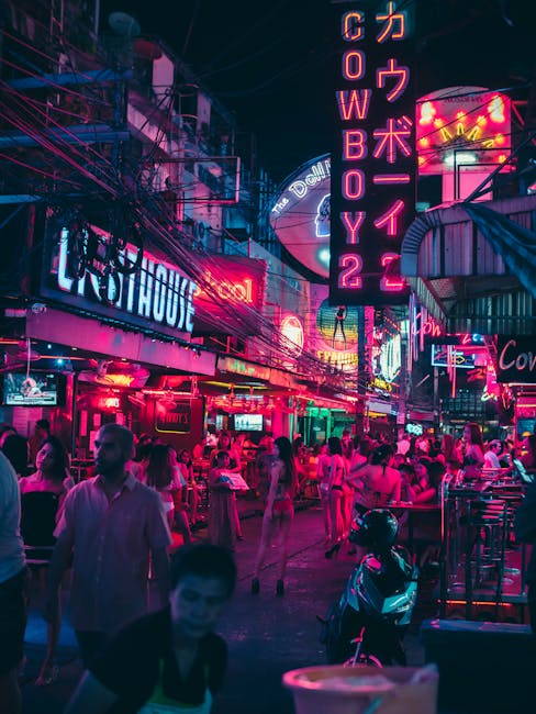 Colorful neon lights illuminate a bustling nightlife scene