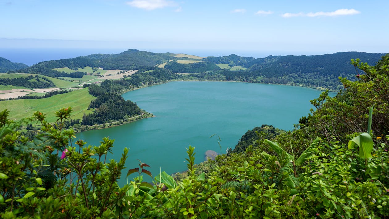 Breathtaking aerial view of a tranquil lake surrounded by green countryside in the Azores